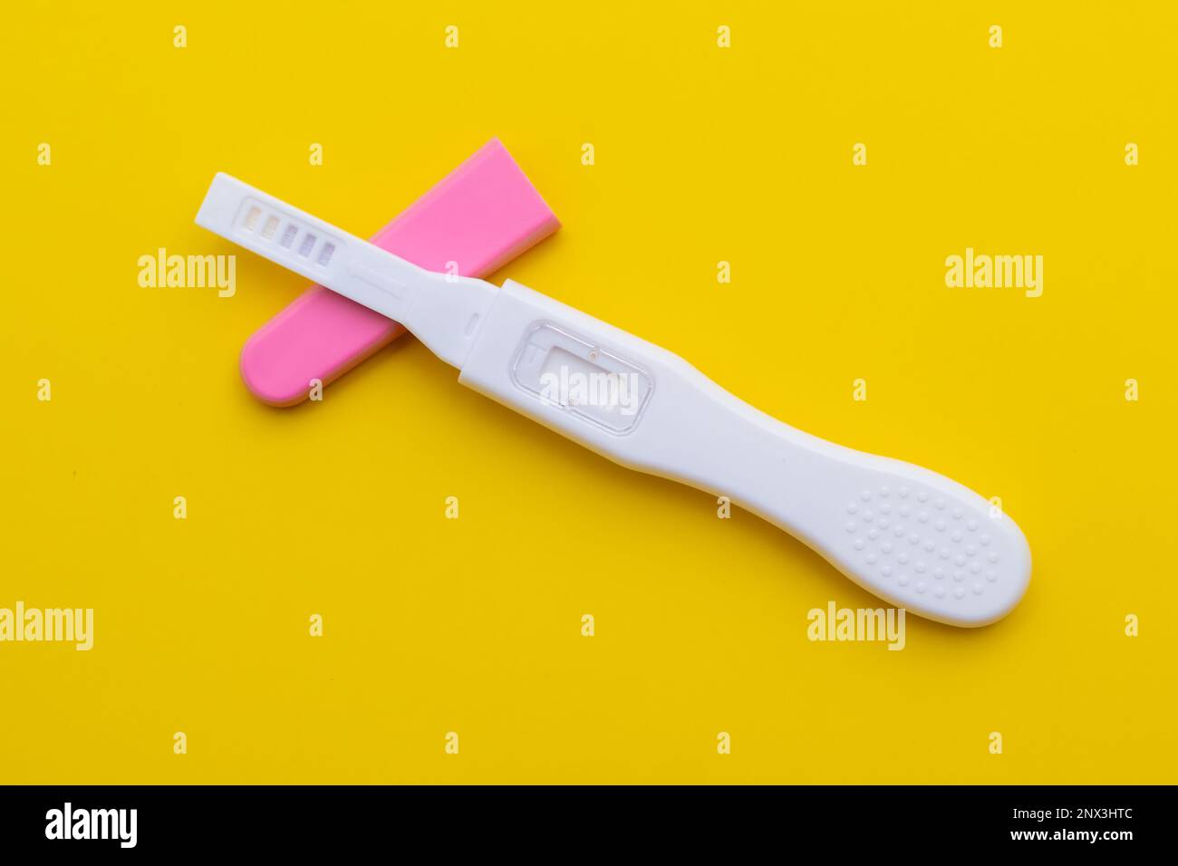 New pregnancy test on the orange background Stock Photo - Alamy