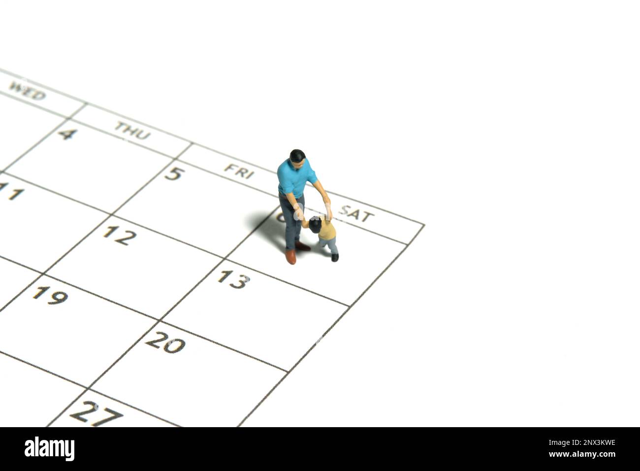 Miniature people toy figure photography. A father and son walking above ...