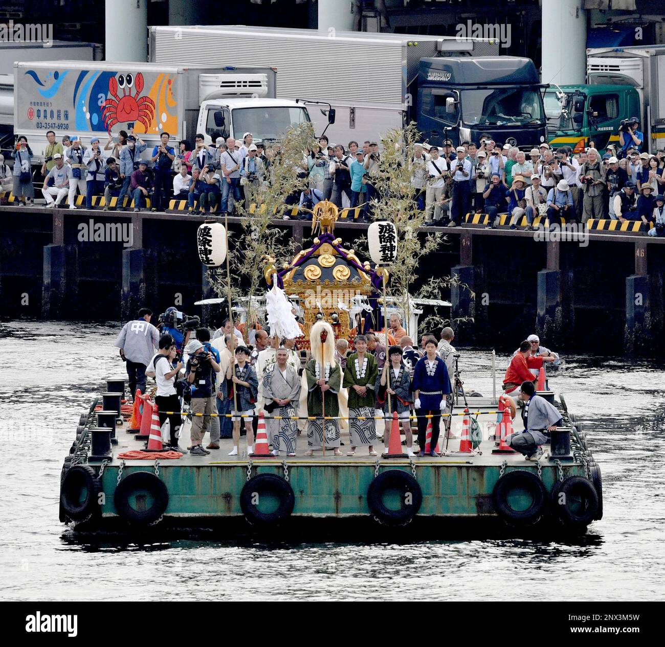 Mikoshi, a portable shrine, on a boat leaves Tsukiji Market during the ...