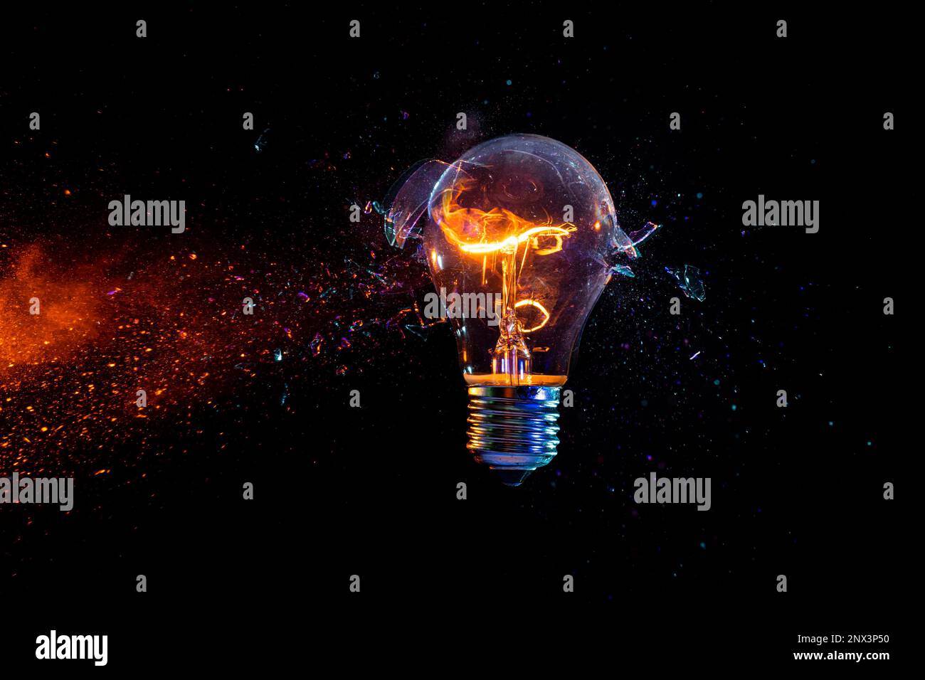 Struck electric bulb breaks into fragments, tungsten filament lit and ...