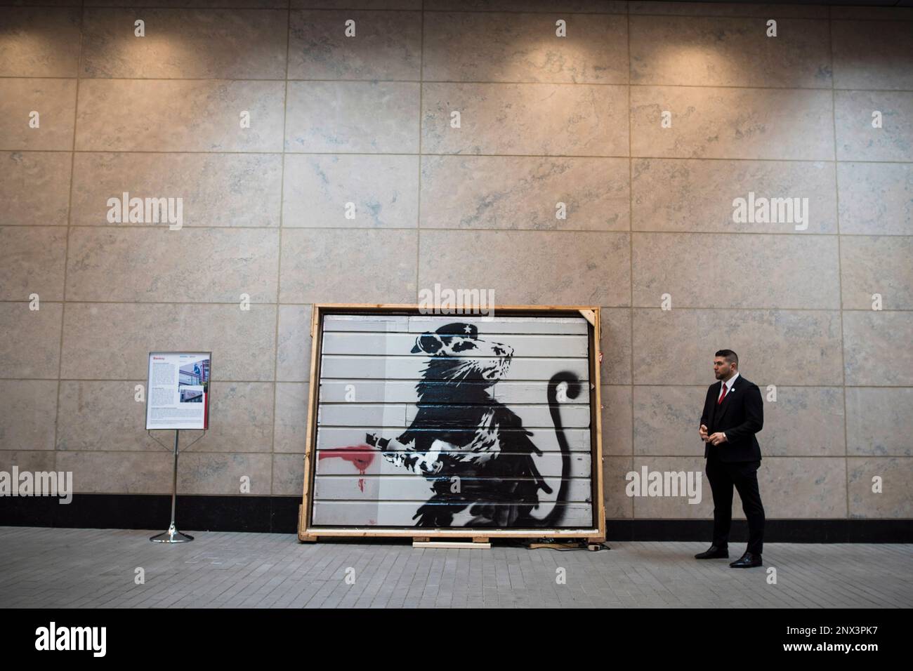 This June 6, 2018, photo shows a security guard standing next to Banksy ...