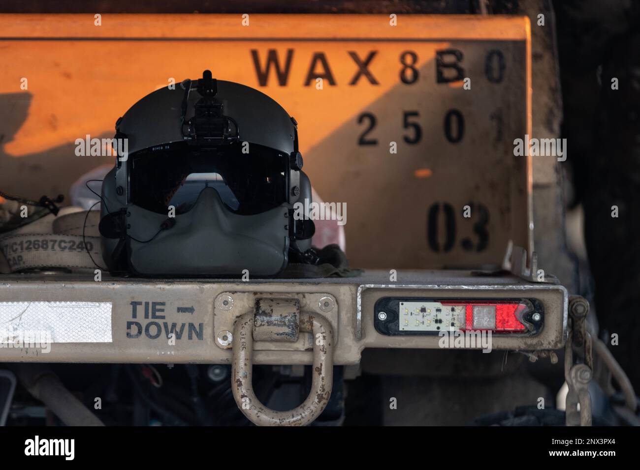 A flight helmet belonging to a CH-47 Chinook Crew Chief Sits and waits ...