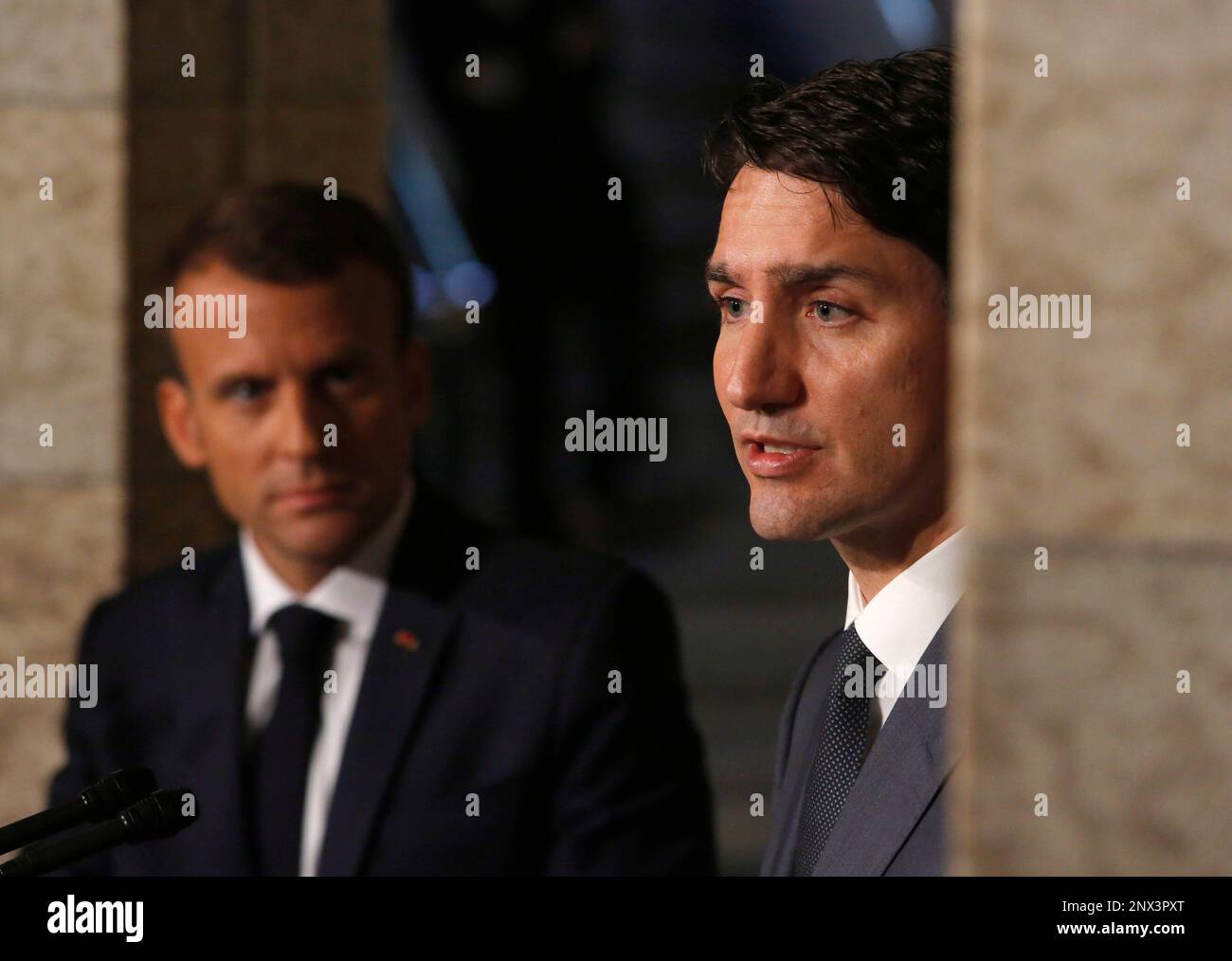 Prime Minister Justin Trudeau and French President Emmanuel Macron give ...