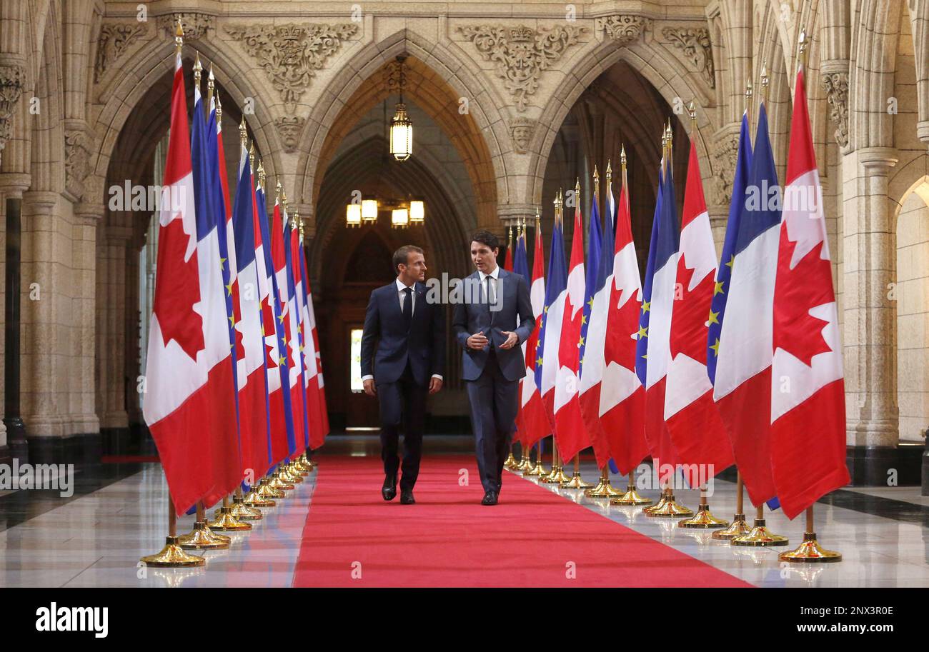 Prime Minister Justin Trudeau and French President Emmanuel Macron walk ...
