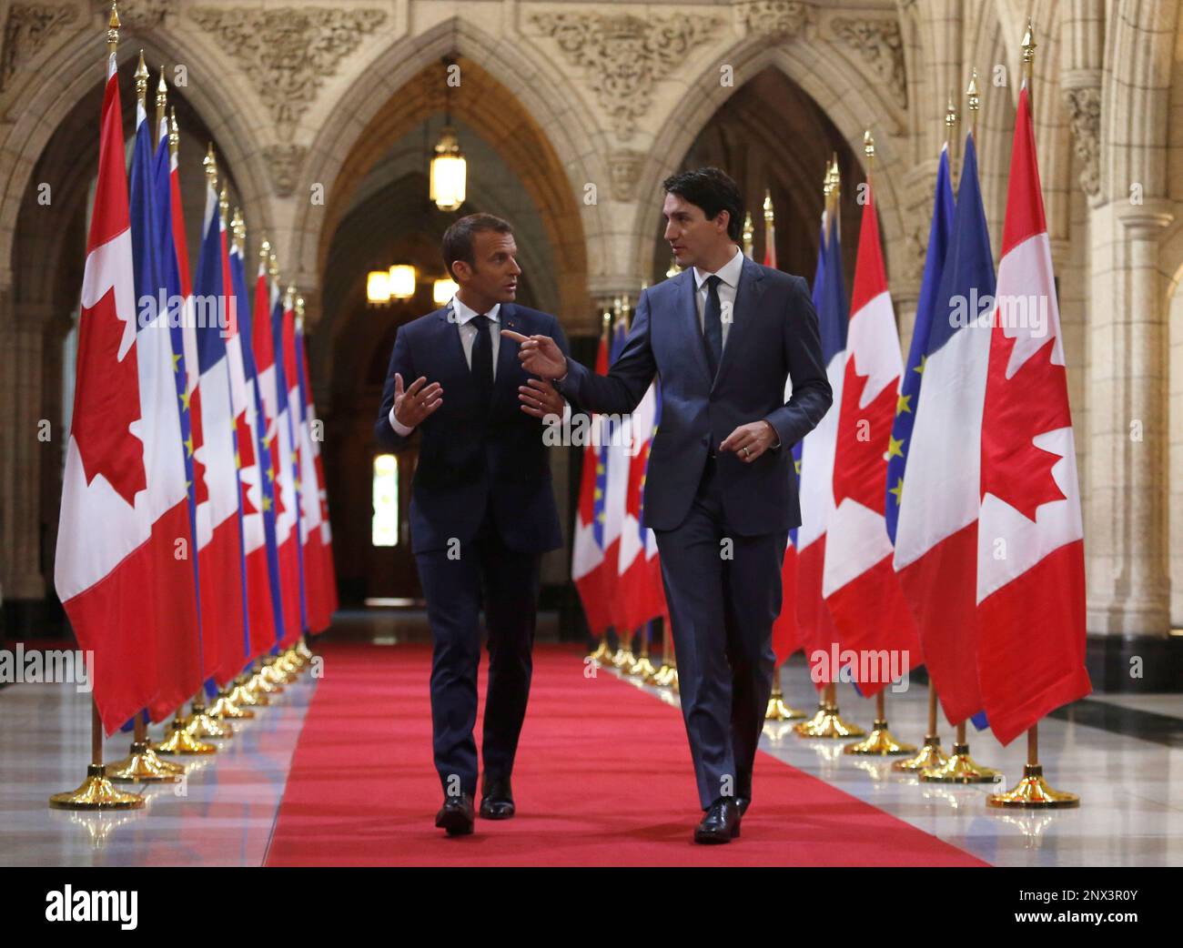 Prime Minister Justin Trudeau and French President Emmanuel Macron walk ...