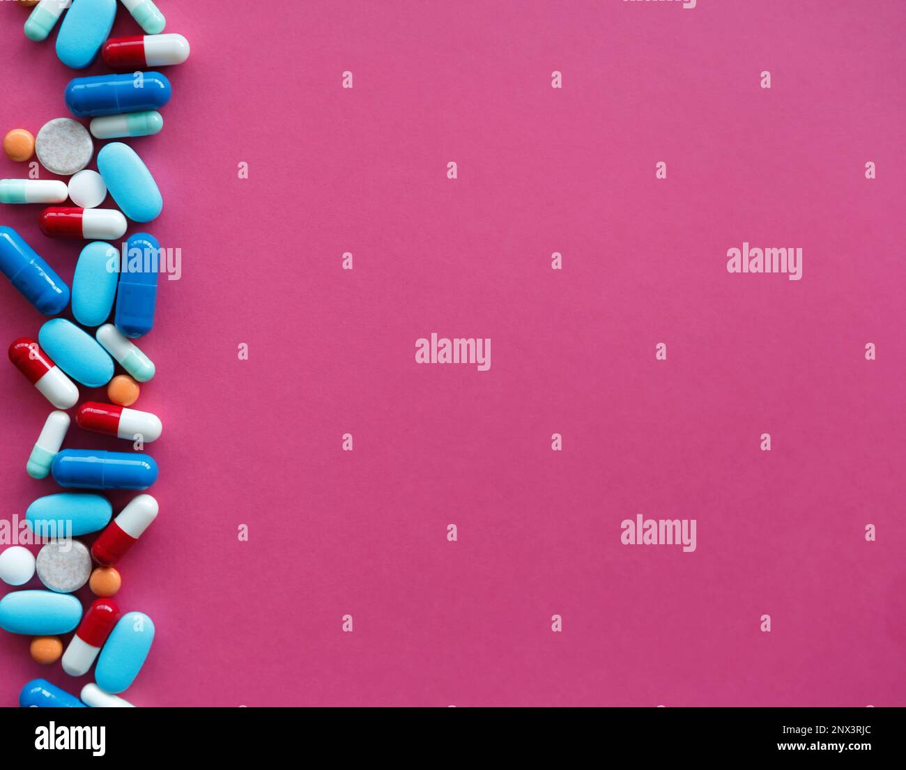 Flat lay background with colorful medical pills and empty space for ...