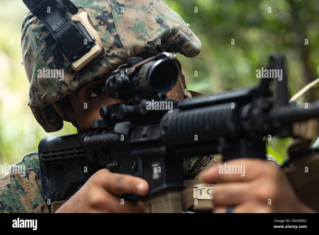 A U.S. Marine with Headquarters Battalion, 3d Marine Division provides ...