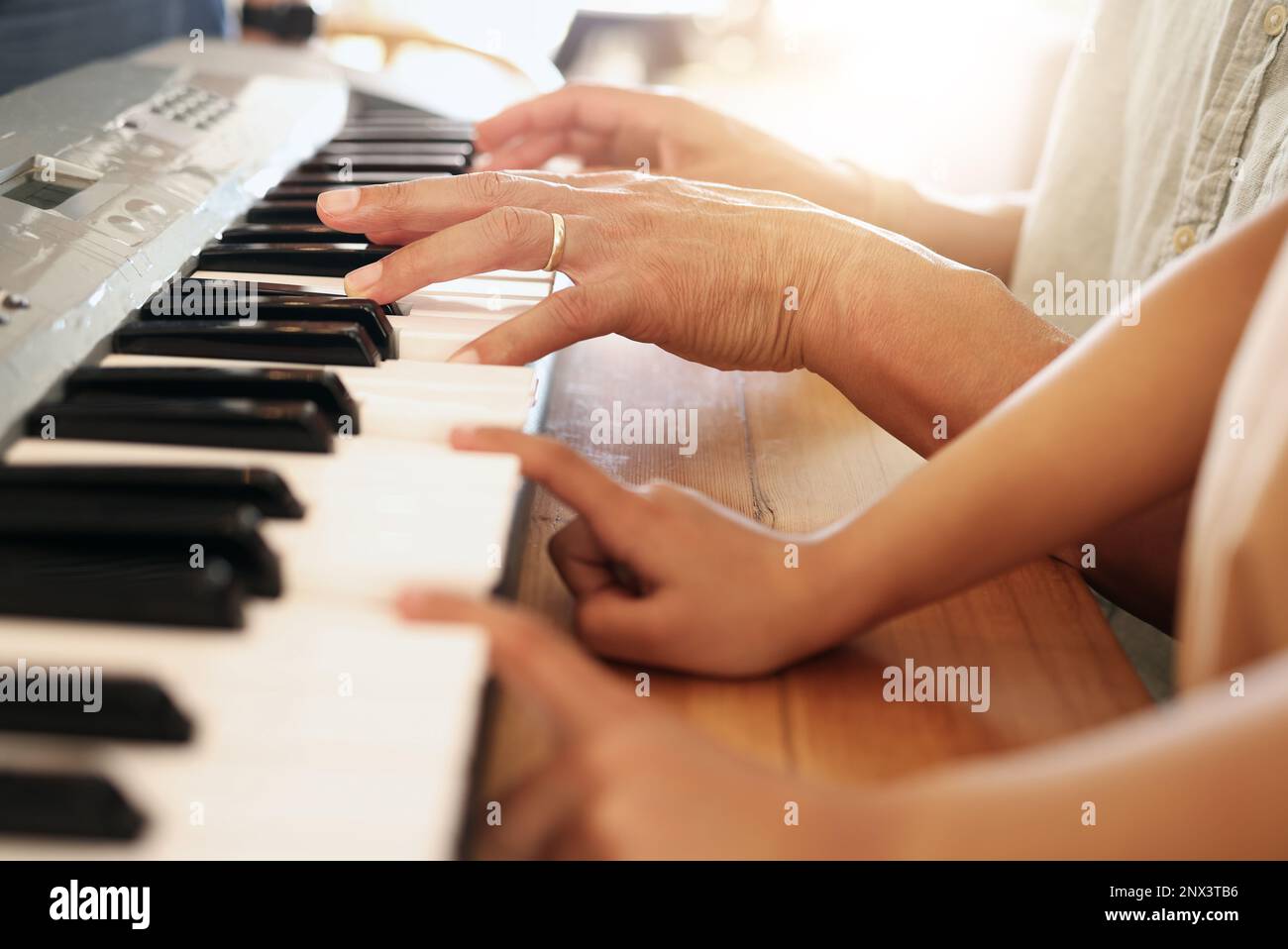 Music lesson, hands of child and piano teacher on keys for development ...