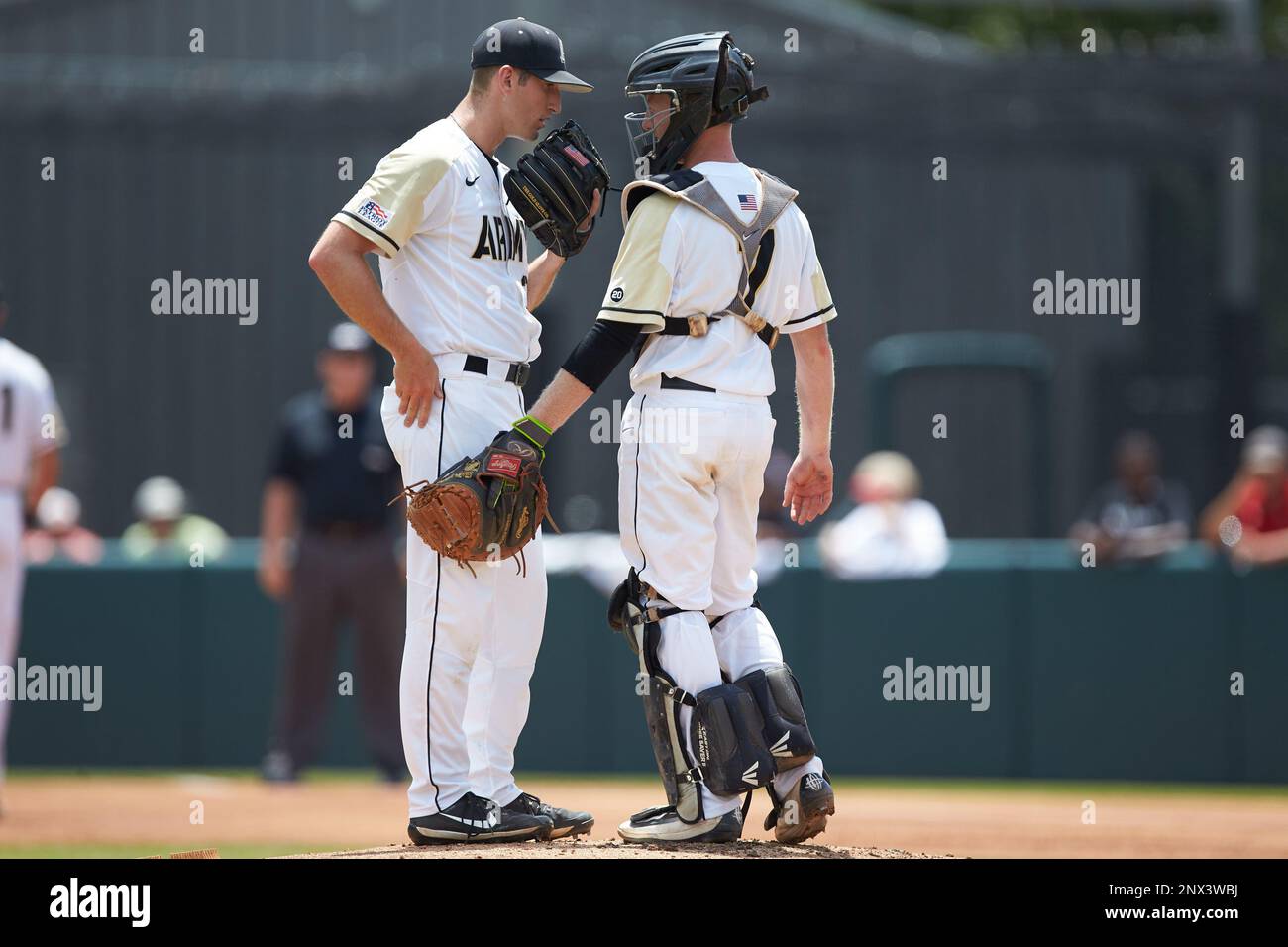 Army Black Knights catcher Jon Rosoff (7) has a meeting on the mound ...