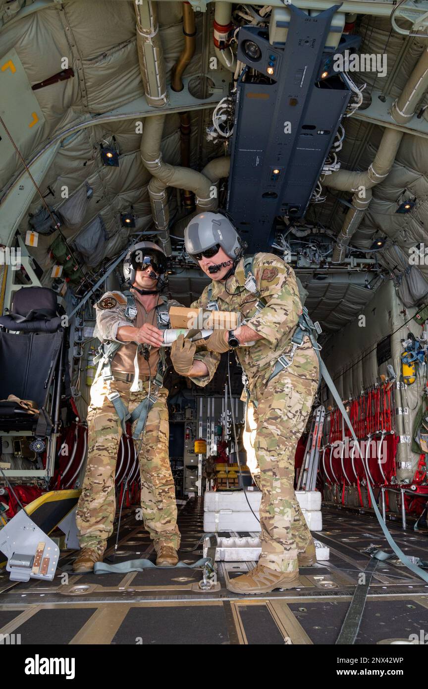 Master Sgts. Spencer Schenkelberg and Justin Neal, 39th Rescue Squadron loadmasters, secure a ...