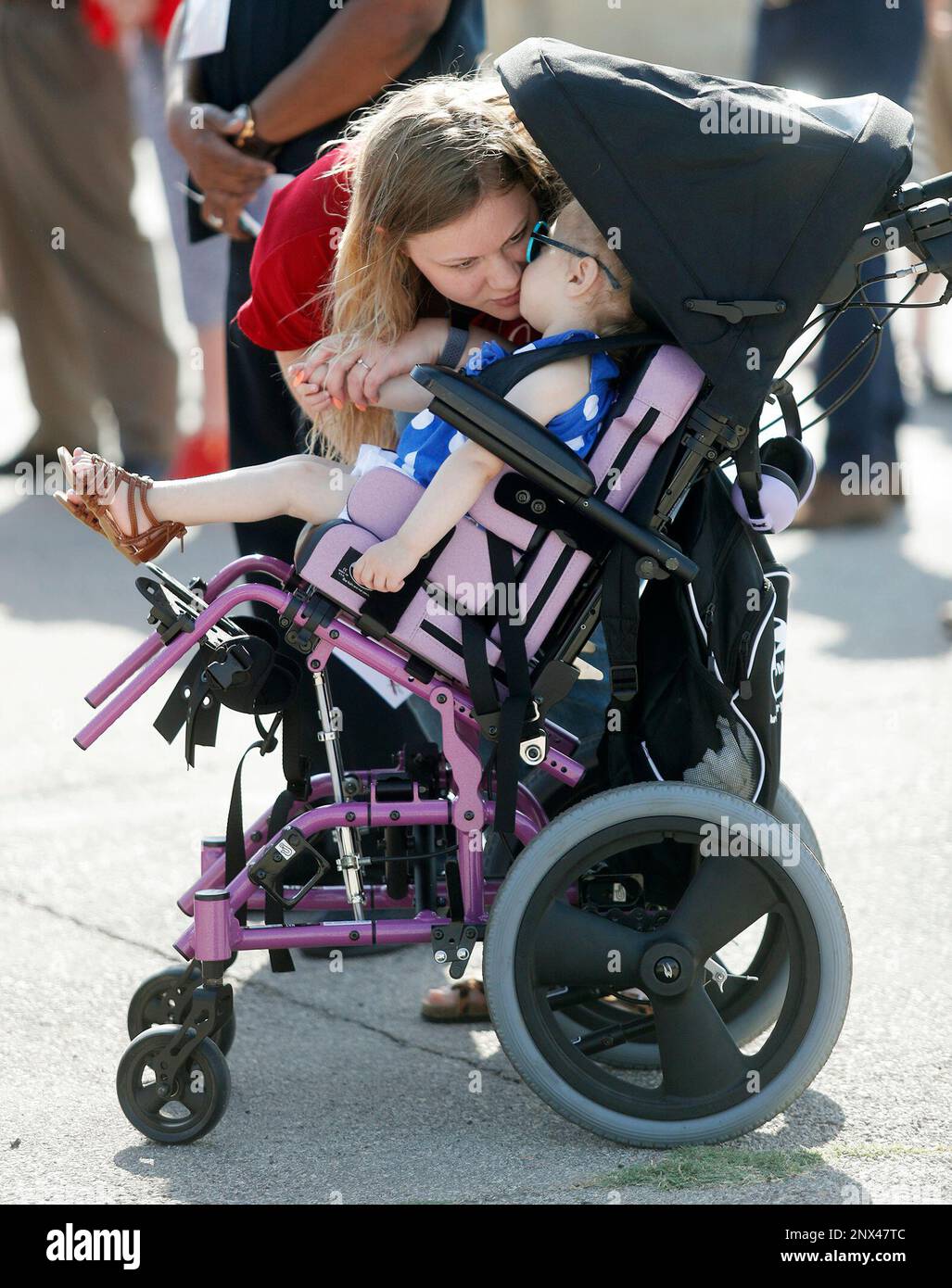 Katie Lindner kisses her 2-year-old daughter Kori Young during the ...