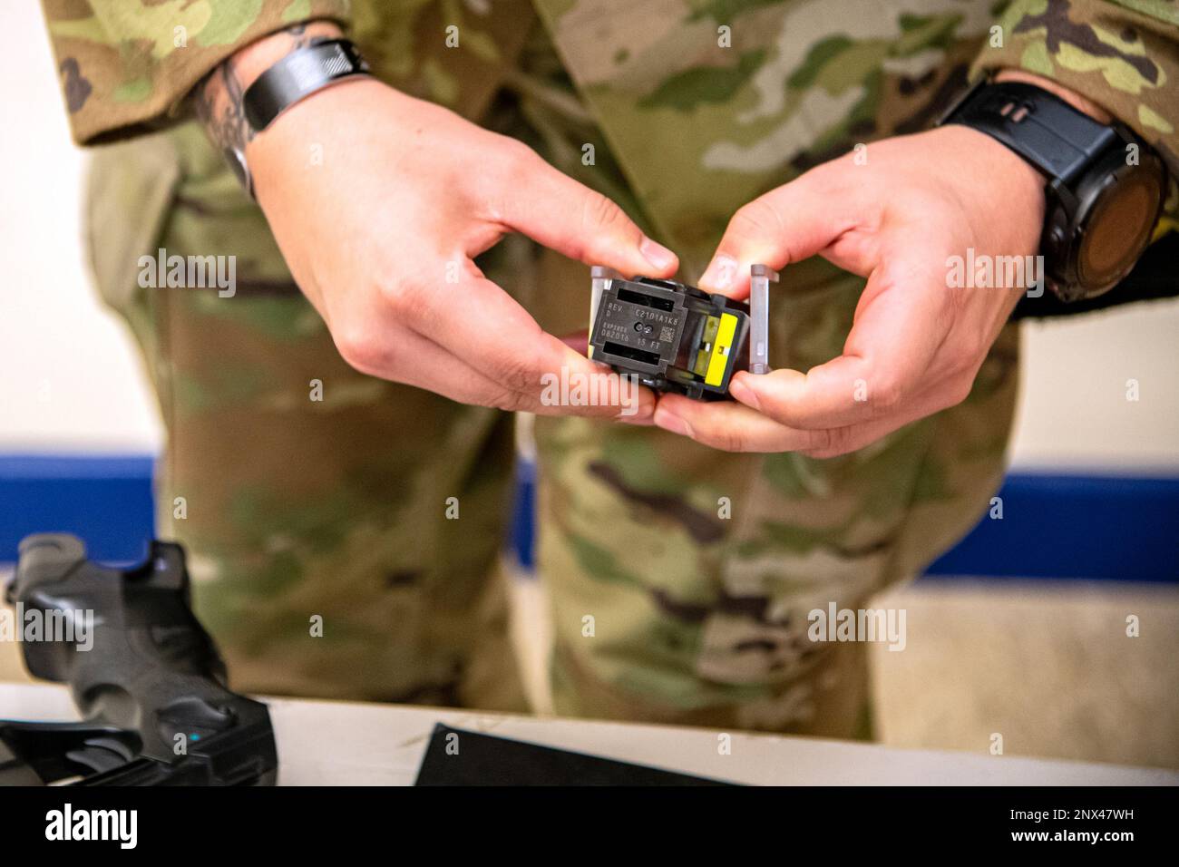 An Airman from the 423d Security Forces Squadron demonstrates a Taser ...