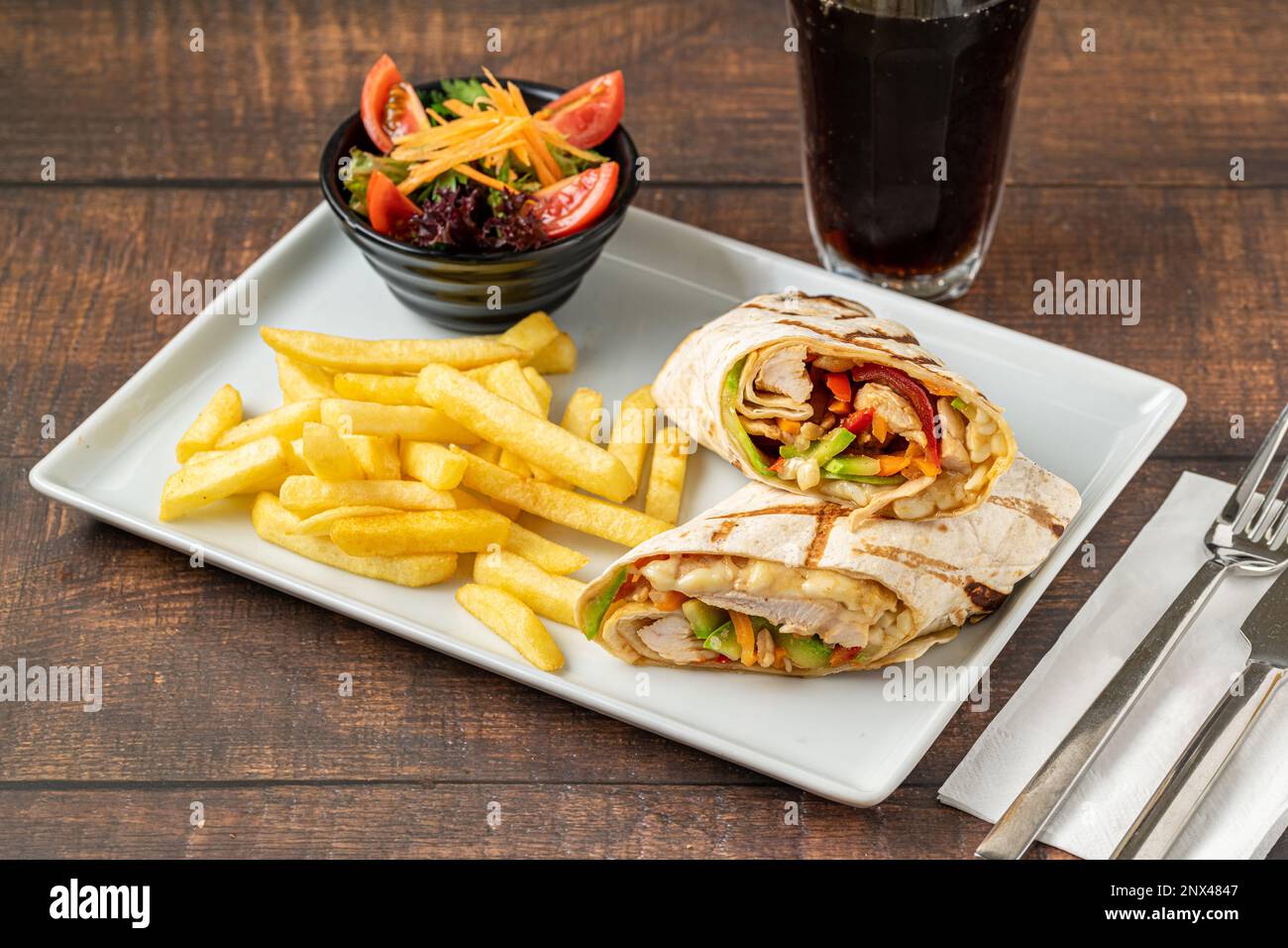 Chicken wrap with french fries and salad Stock Photo - Alamy