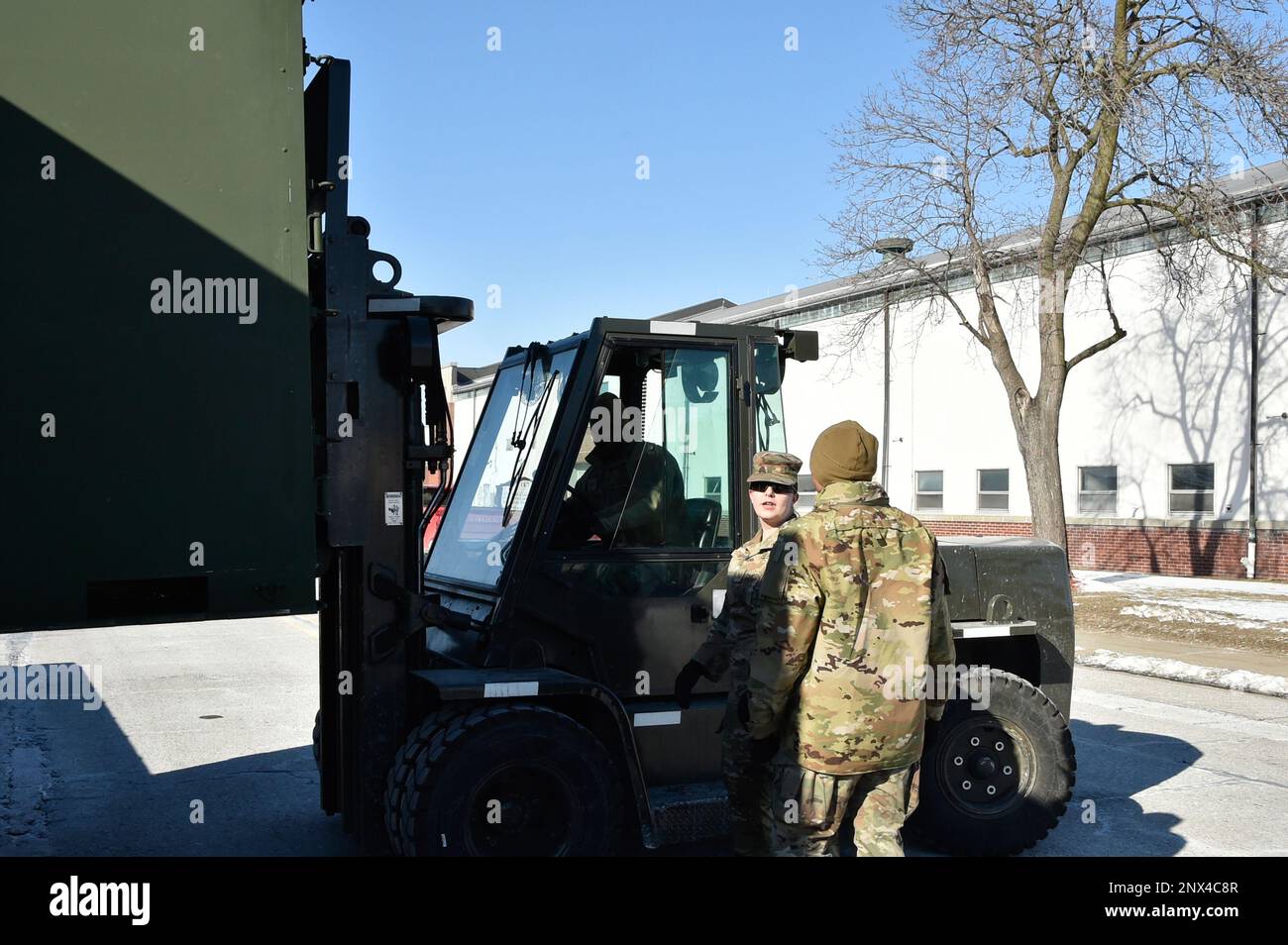 Members of the 127th Logistics Readiness Squadron load a standard ...