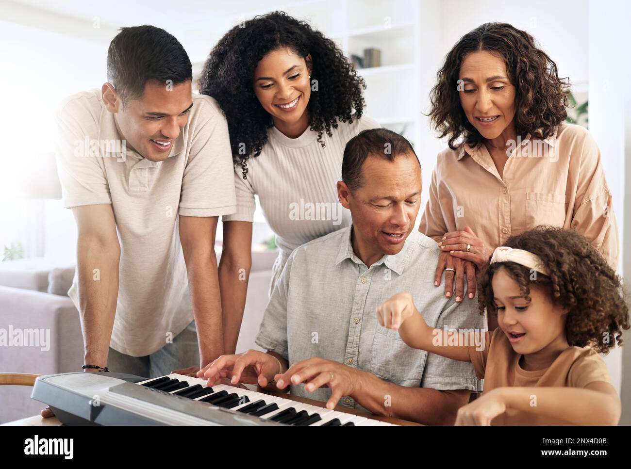 Family, keyboard piano and play music with grandparents, parents and ...