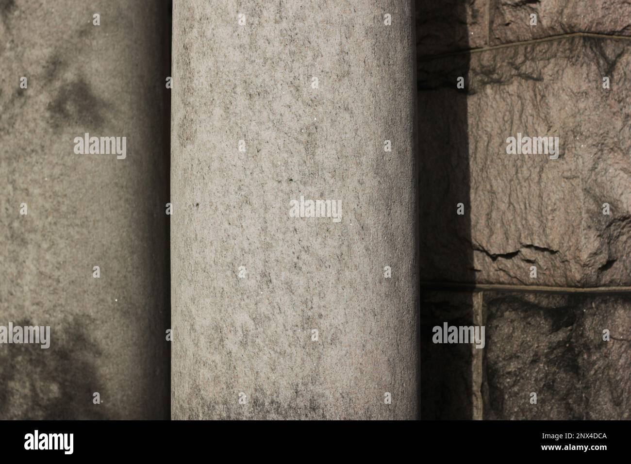 A minimalist closeup view of a fluted column carved in natural stone ...