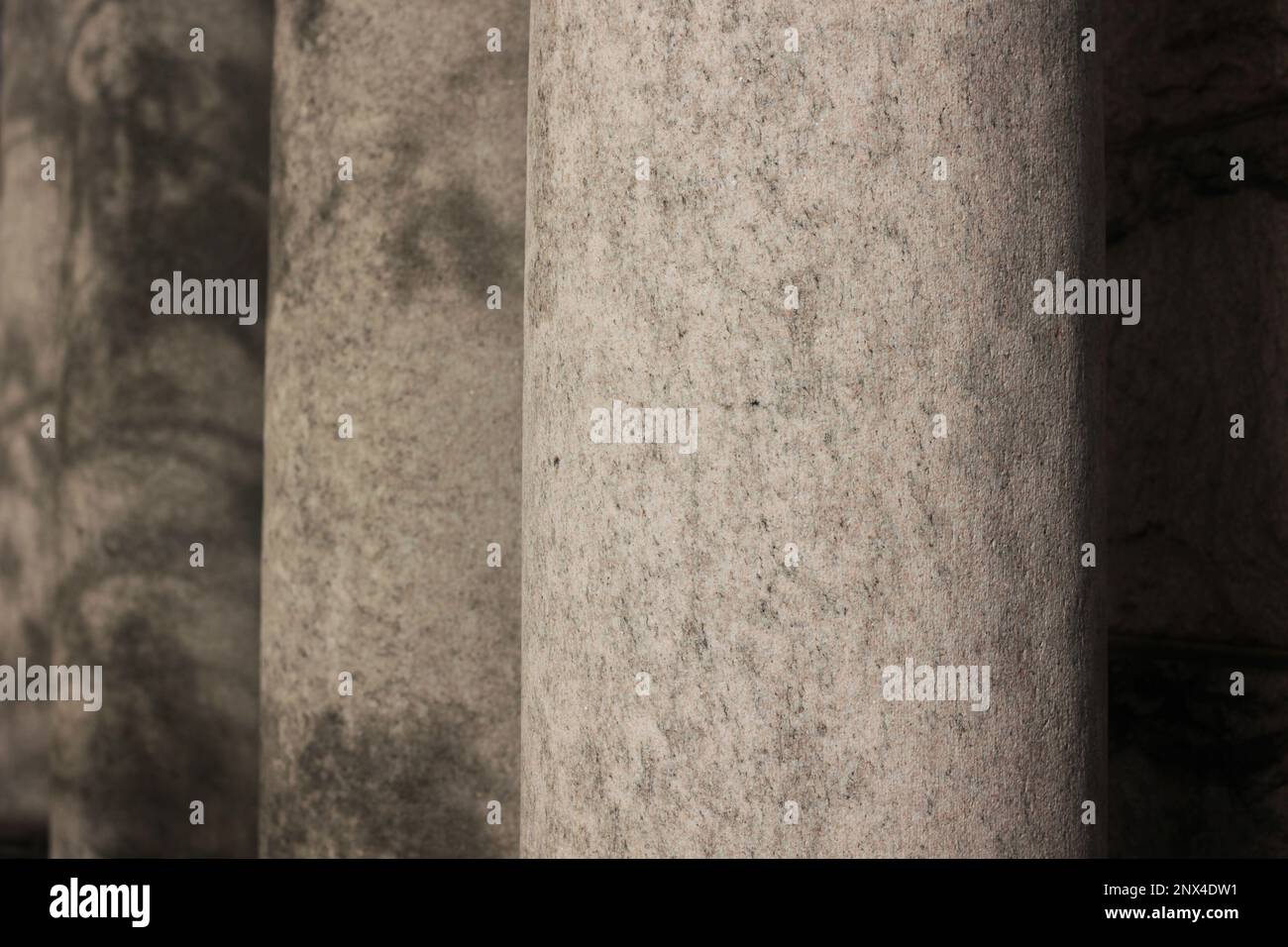 A minimalist closeup view of a fluted column carved in natural stone ...