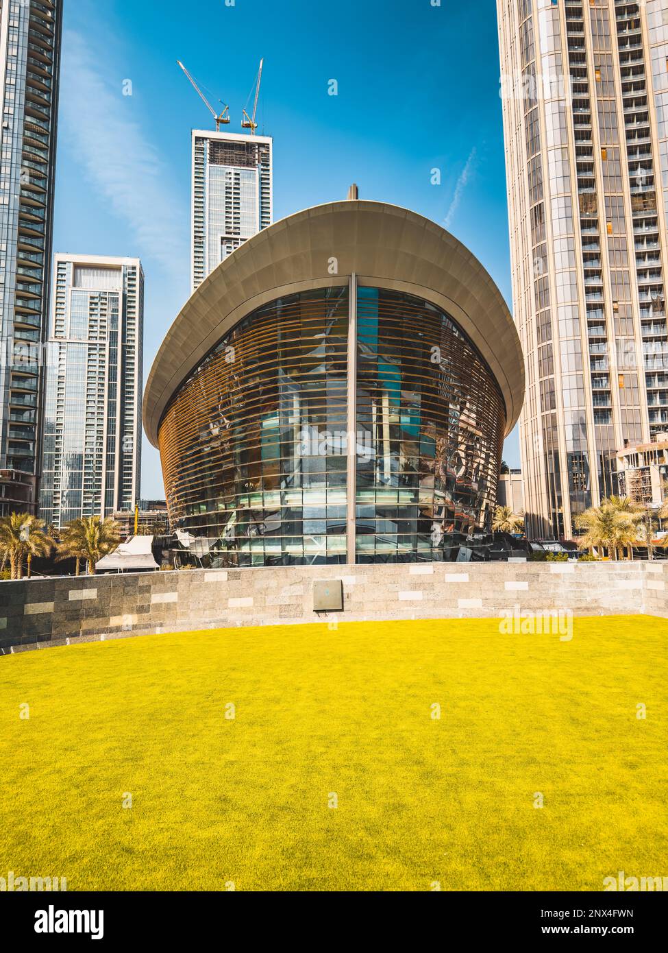 Dubai Opera house in Downtown Dubai, surrounded by skyscrapers and Burj ...