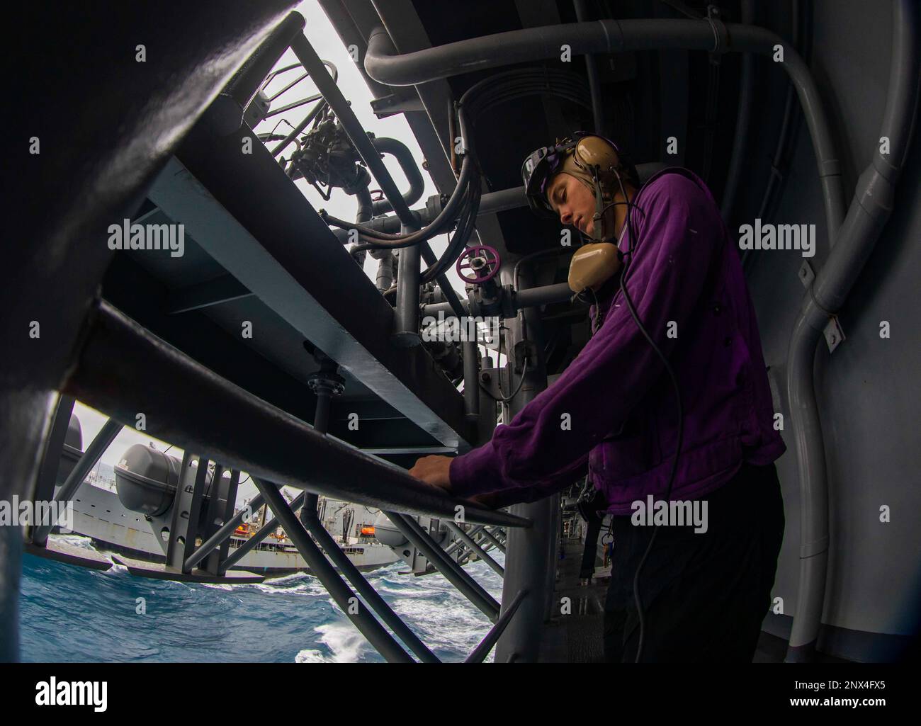 230121-N-XK047-1028 Airman James Muth stands an overboard discharge ...