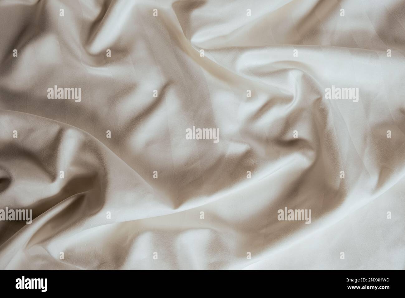 Abstract beige fabric background, satin stripe texture, wavy folds of ...