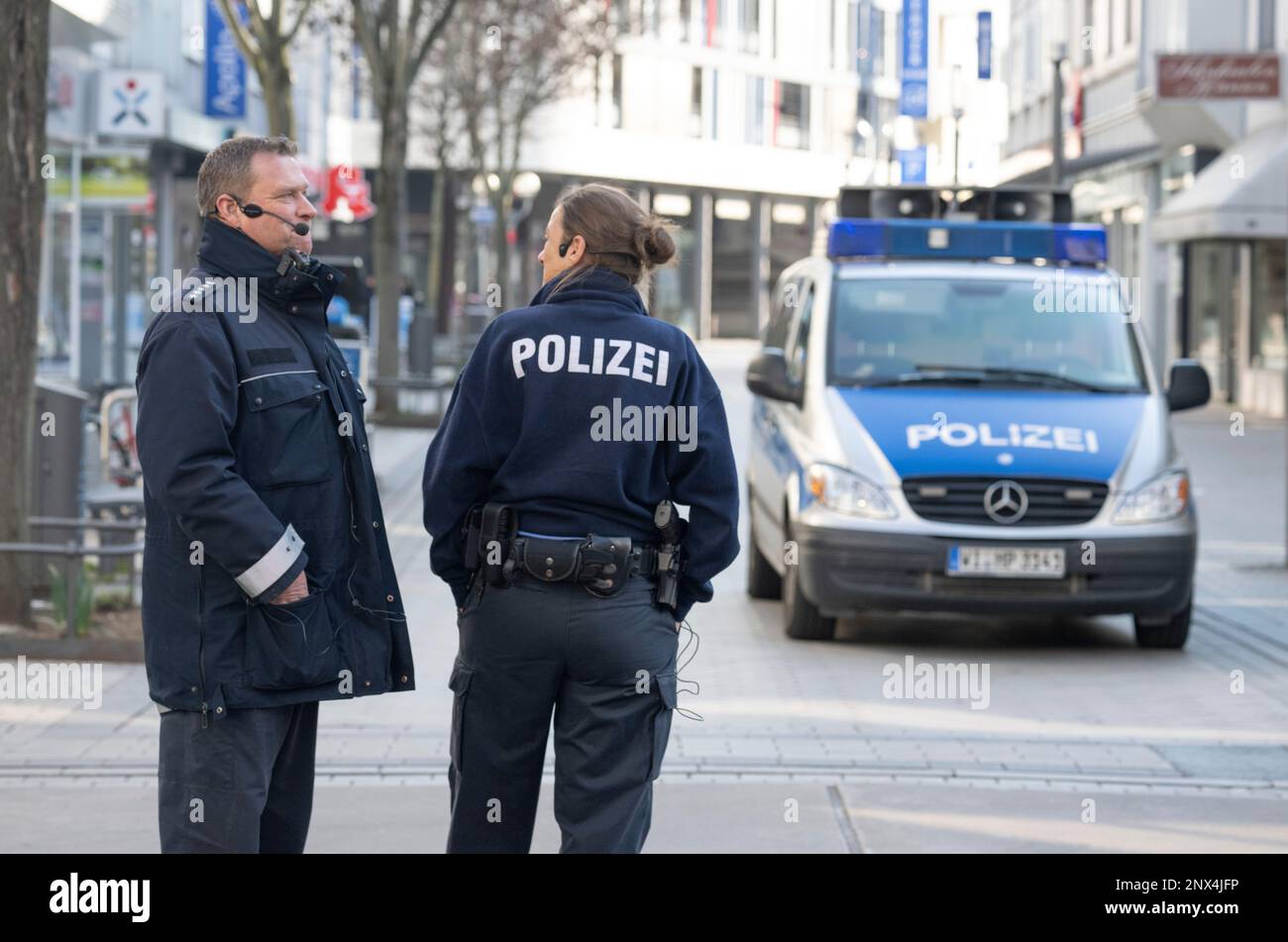 Hanau, Germany. 01st Mar, 2023. A policeman and a policewoman stand in ...