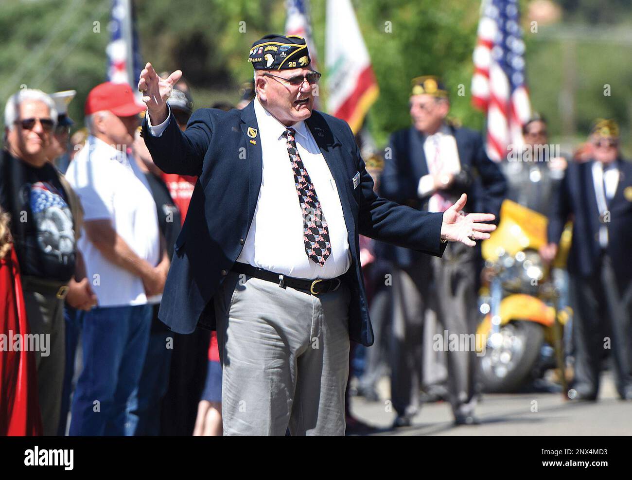 Don Dowling speaks as veterans line up in front of the crowds Monday ...