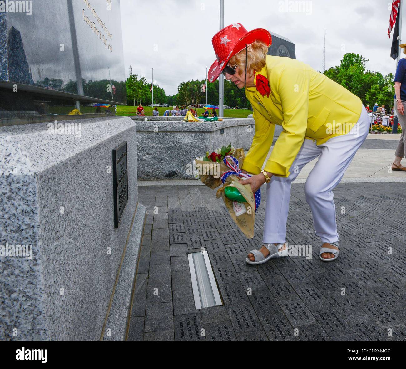 Barbara Linnane Guest places flowers on the memorial of her late ...