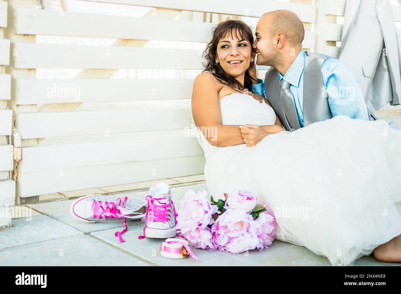 Young newlyweds having rest together talking after wedding ceremony ...