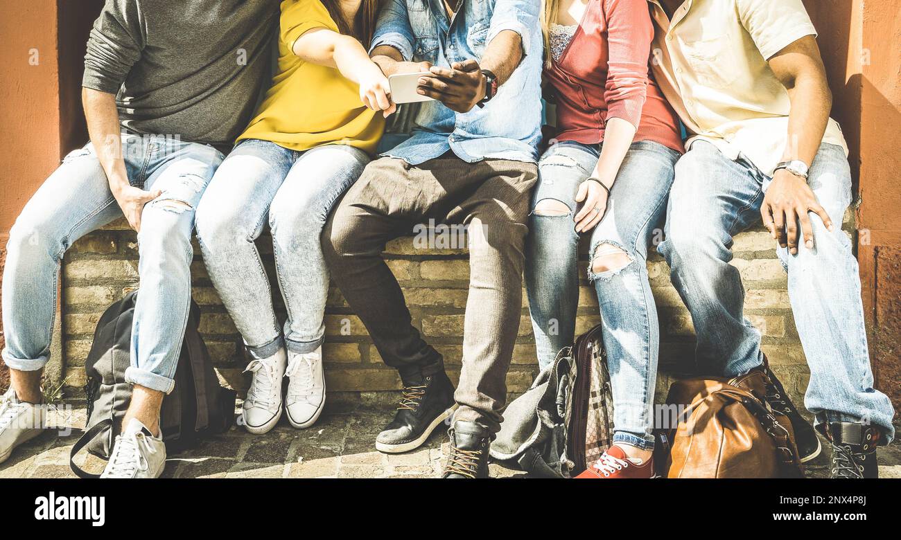 Group of multiculture friends using smartphone on urban background ...
