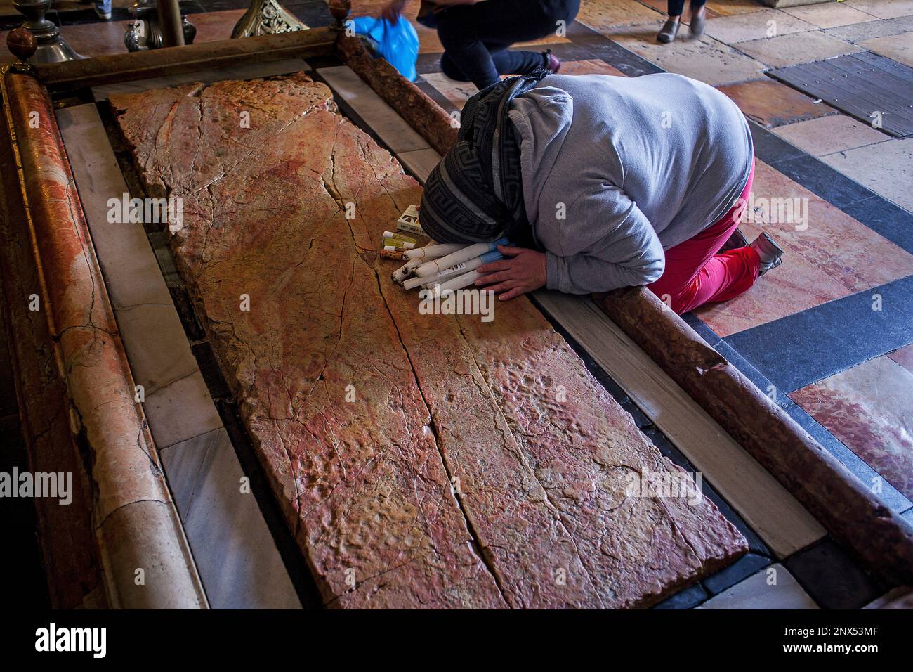 Woman praying,Stone of Unction, Church of the Holy Sepulchre also ...