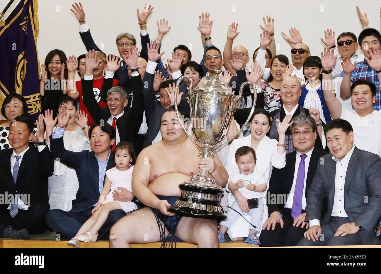 Mongolian yokozuna Kakuryu (C) celebrates with his supporters after ...
