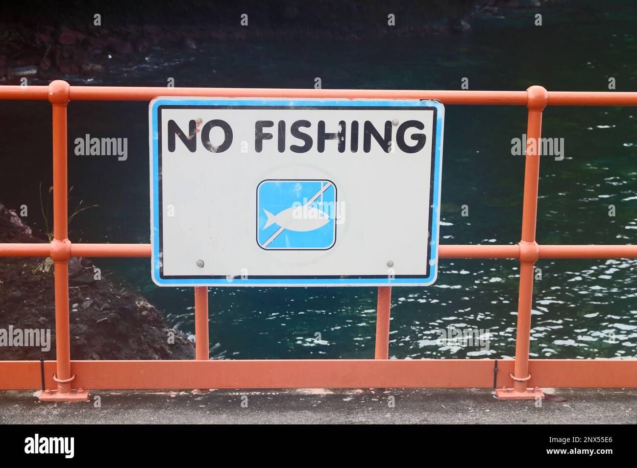 No Fishing sign attached to bridge over waterway Stock Photo - Alamy