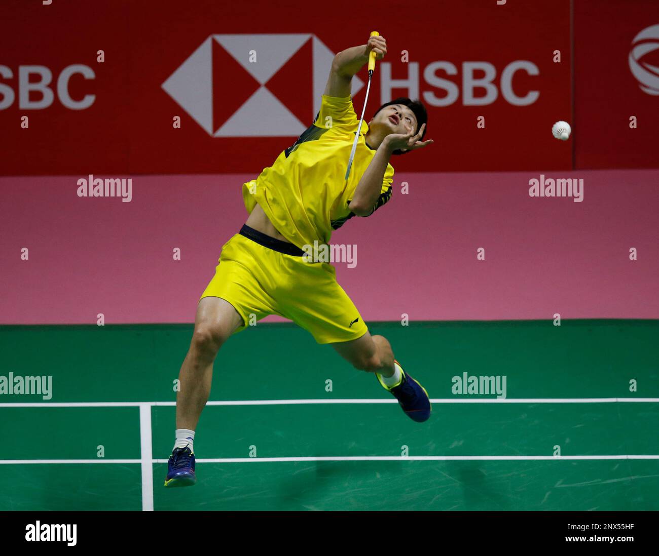 Shi Yuqi of China returns a shot to Kenta Nishimoto of Japan during ...