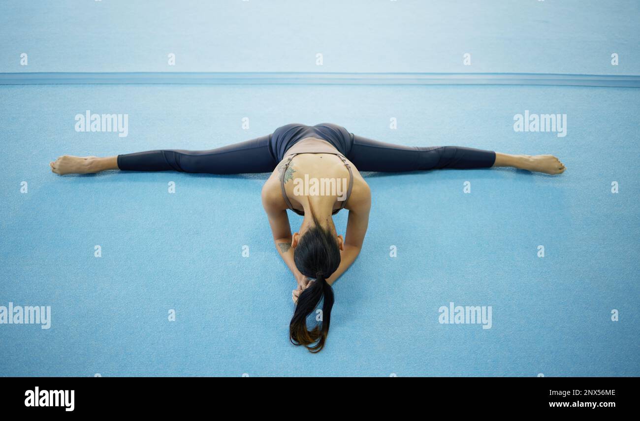 Above, stretching and woman doing gymnastics on the floor, fitness warmup and flexibility from ...