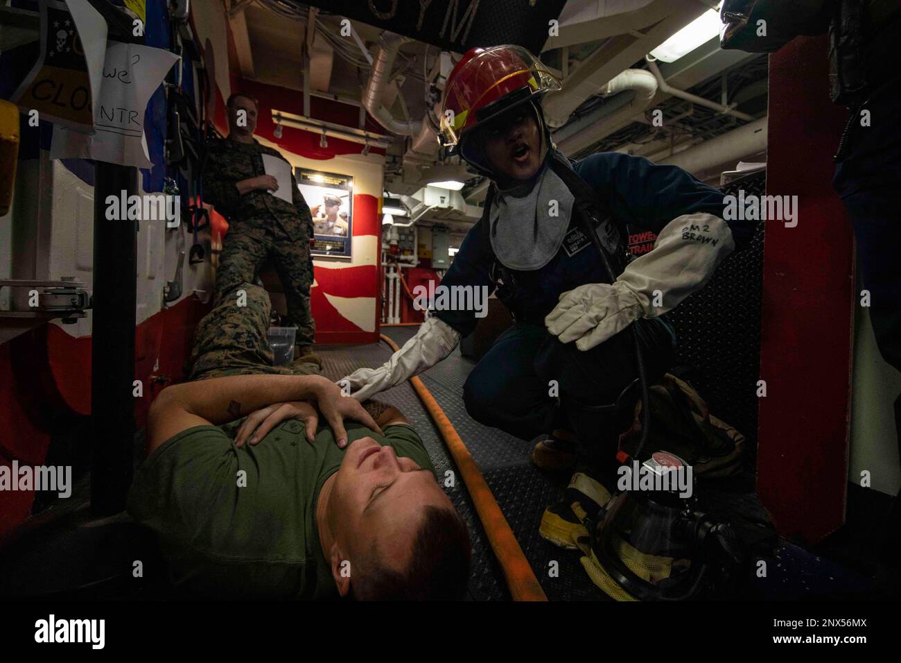 230106-N-VS068-1010 Boatswain’s Mate 2nd Class Ashley Brown assists a ...