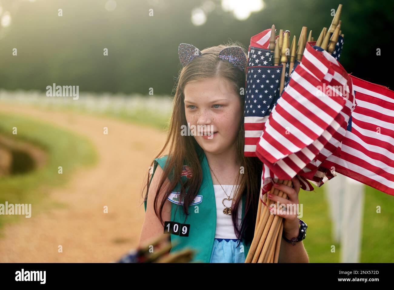 Girl Scout Caitlyn Hootsell, 10, carries a bundle of U.S. flags ...