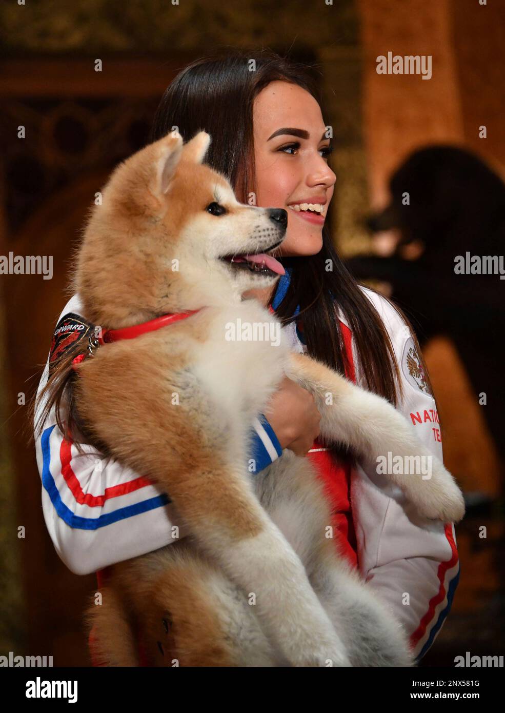 Russia's figure skater Alina Zagitova holds a baby Akita Inu dog named ...