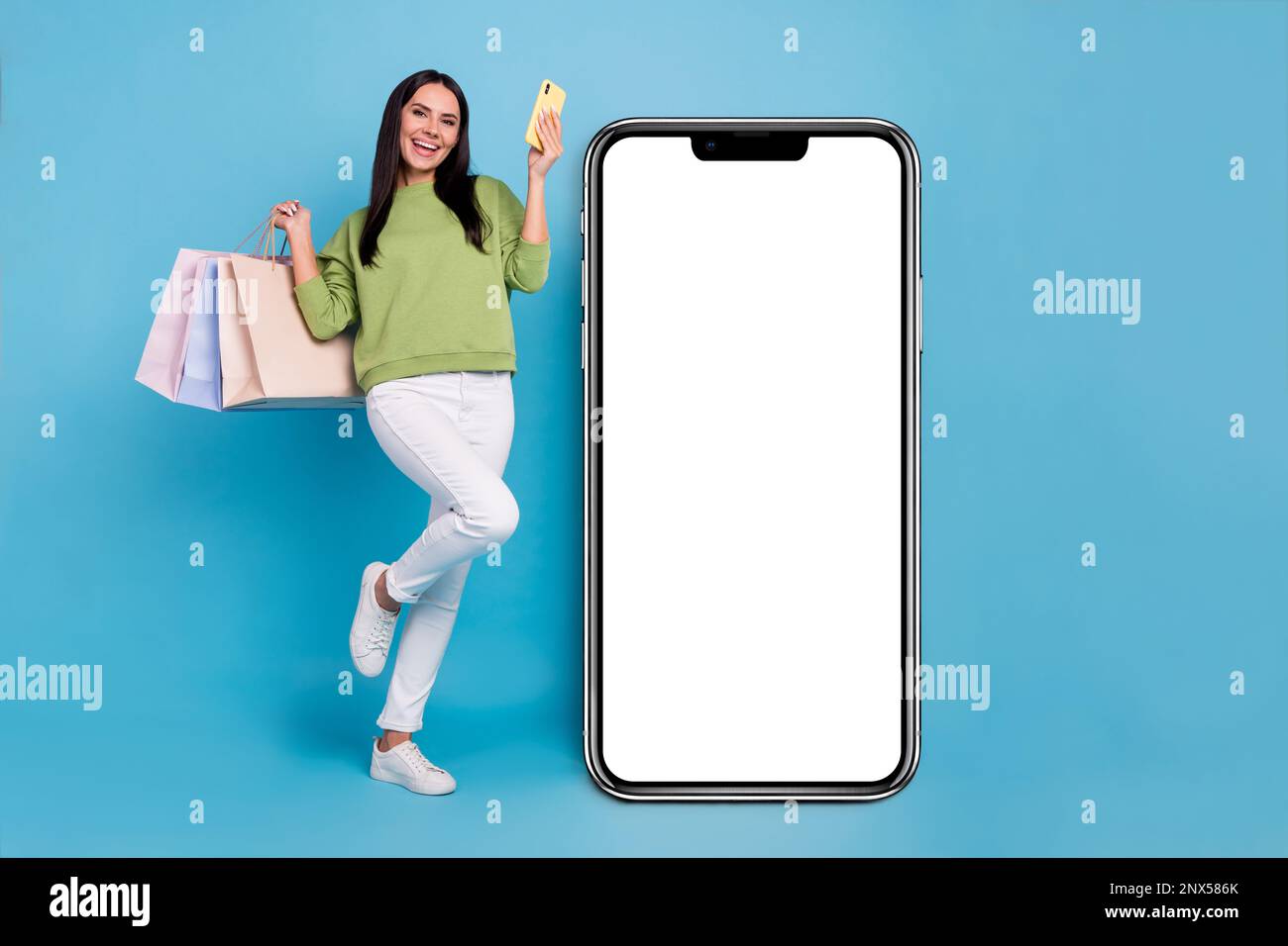 Full body portrait of overjoyed cheerful girl hold packages empty space ...