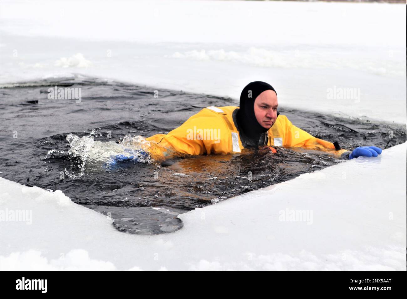 A firefighter wearing a cold-water immersion protective suit acts as a ...