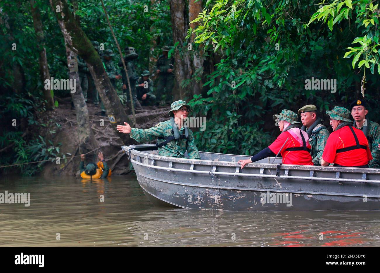 President Halimah Yacob watching SAF officer cadets crossing a river ...