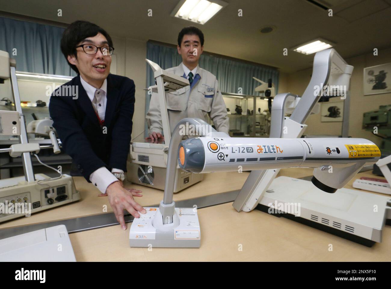 A staff explains about Document Camera at a museum of ELMO Co. in ...