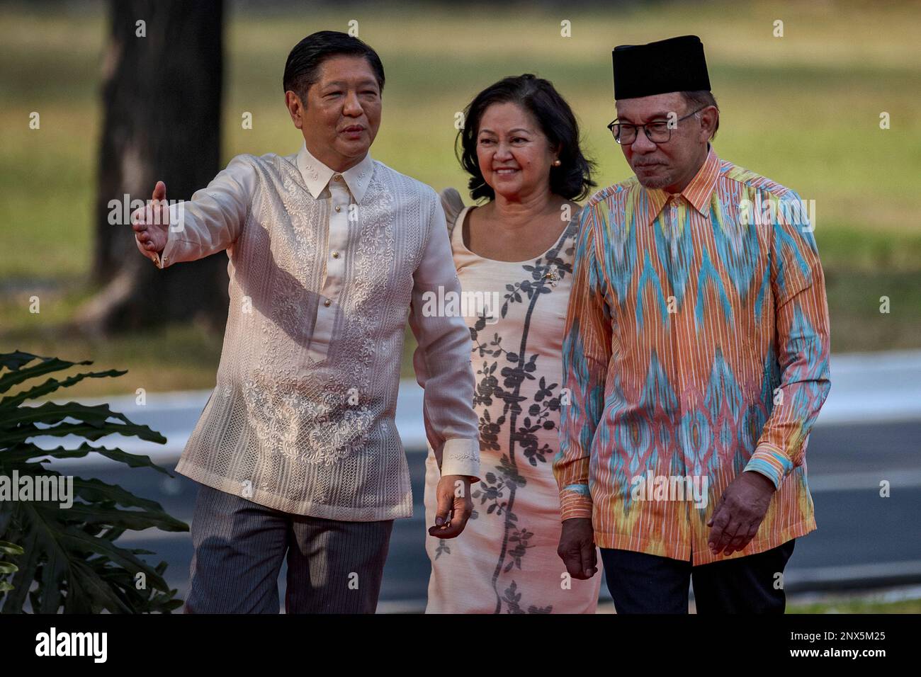 Malaysian Prime Minister Anwar Ibrahim, right, walks together with ...