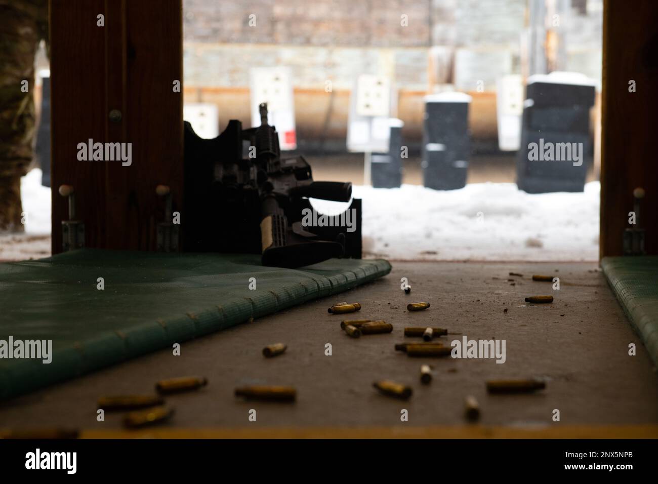 An M4 Carbine rifle is surrounded by bullet casings during a shooting ...