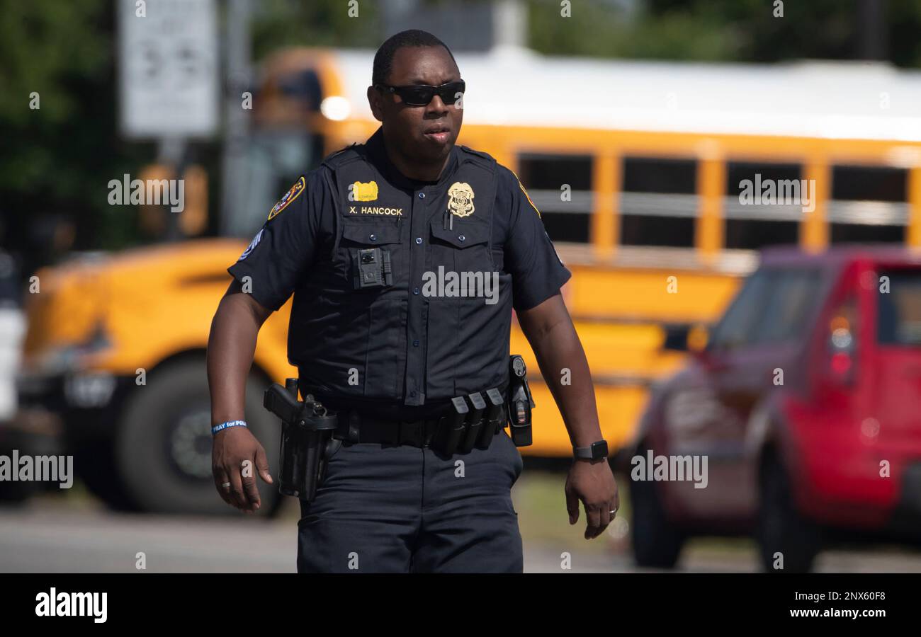 Galveston Police officer Xavier Hancock works at the scene of a ...