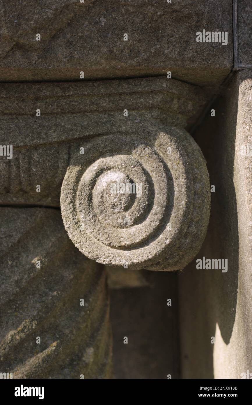 A typical Greek column capital hiding in the leaves of the vines Stock ...