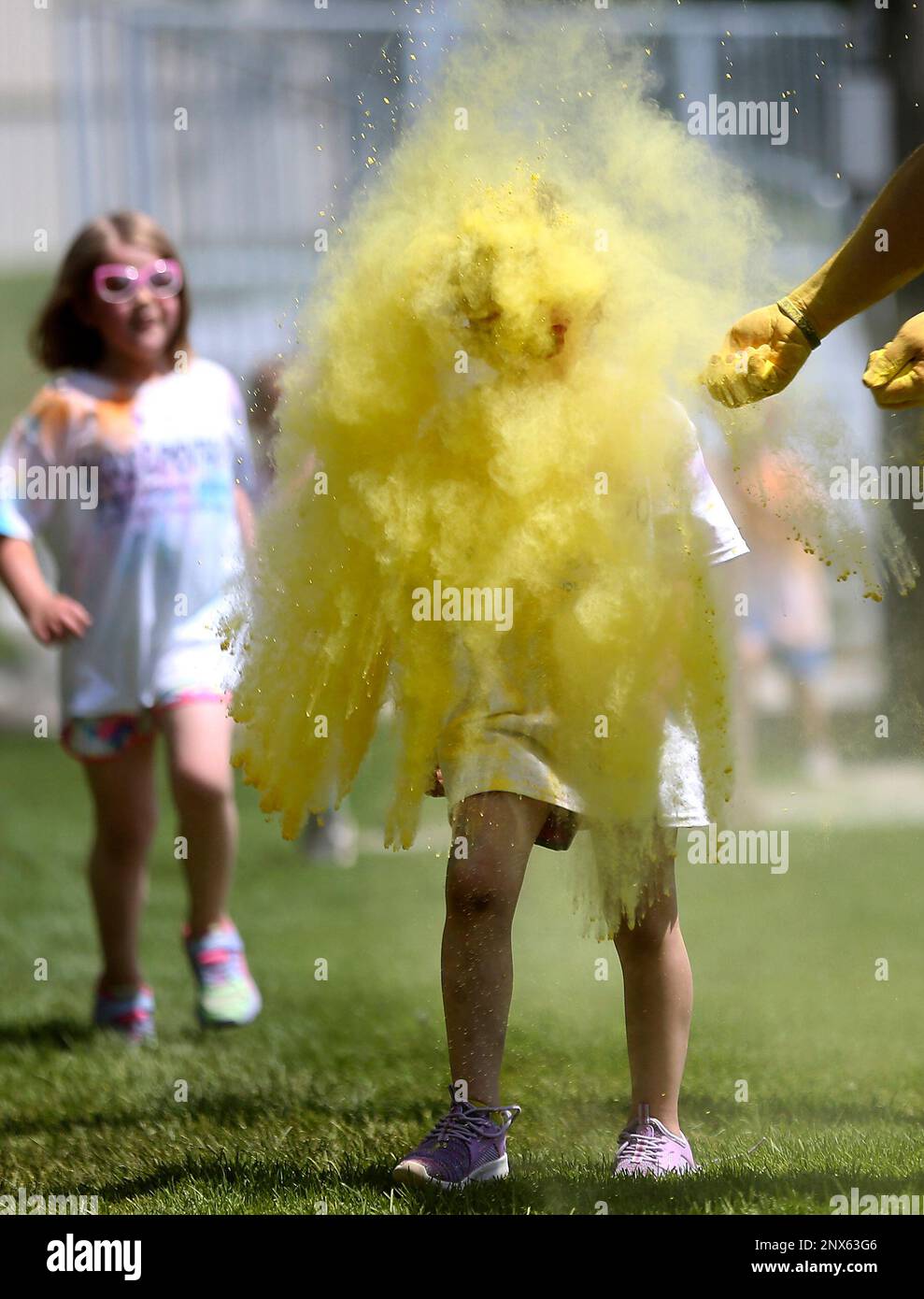 A Cascade Elementary School student gets covered with color while ...