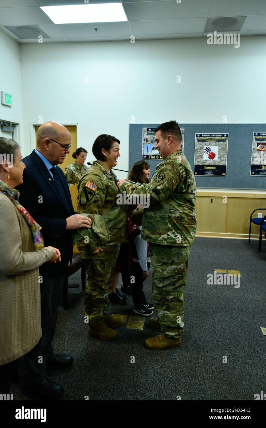 Retired U.S. Army Lt. Col. Mike Doyle pins the rank of colonel on his wife, Col. Amanda Doyle ...