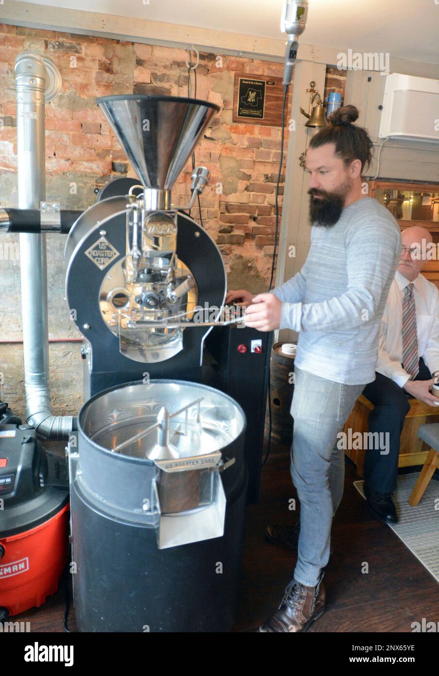 Matthew DuTrumble shows the roaster inside Craftsman Cliff Roasters at ...
