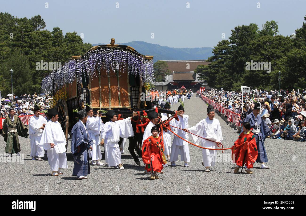 An ox carriage (front) and the people dressed Heian Period costumes ...