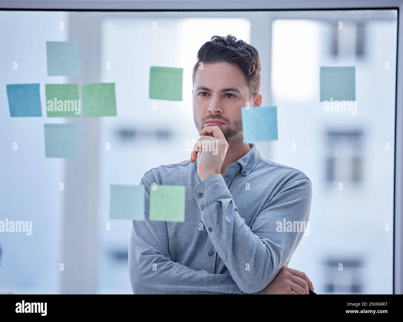 Creative man, thinking and brainstorming in schedule planning glass ...